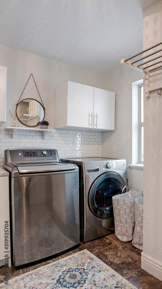Vertical Laundry room interior with cabinets wahing machine and dryer ...