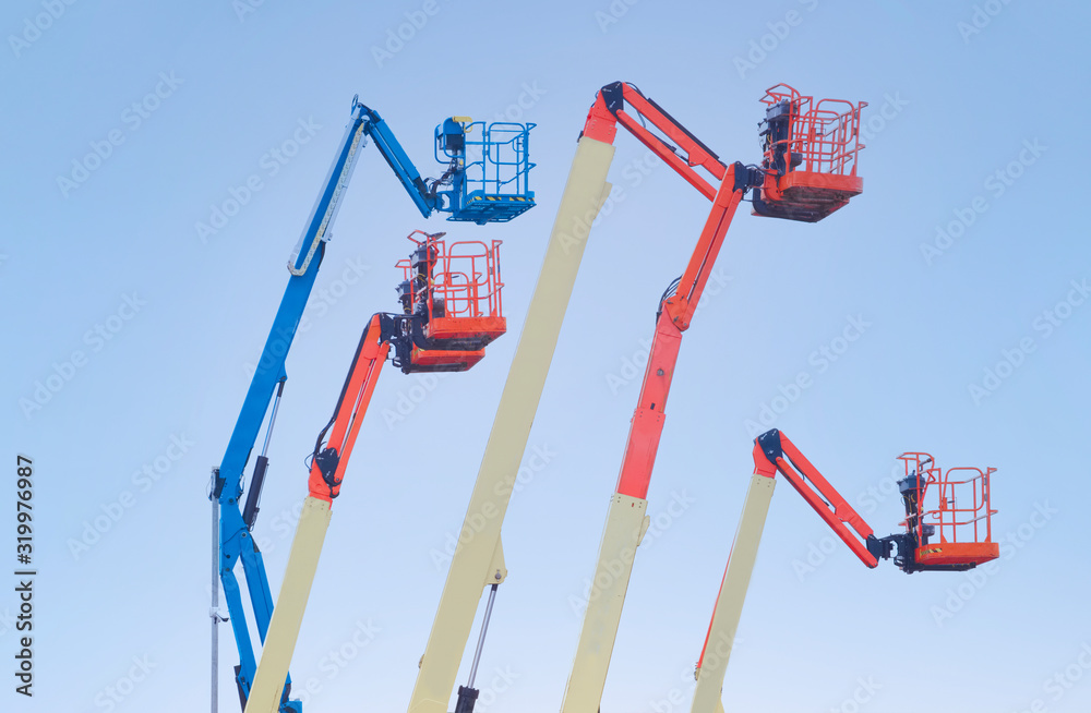 Access platform equipment powered high in sky in blue orange and yellow ...