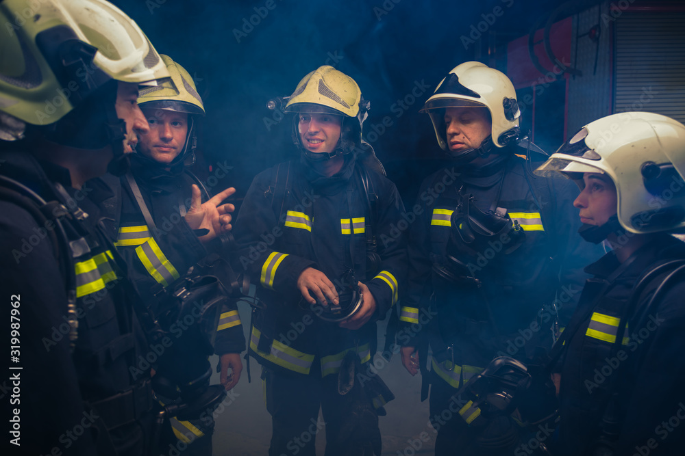 Group of firemen in the fire department organizing action plan for safe ...