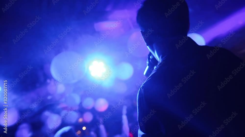 Back view of singer with microphone in the rays of stage light Stock ...