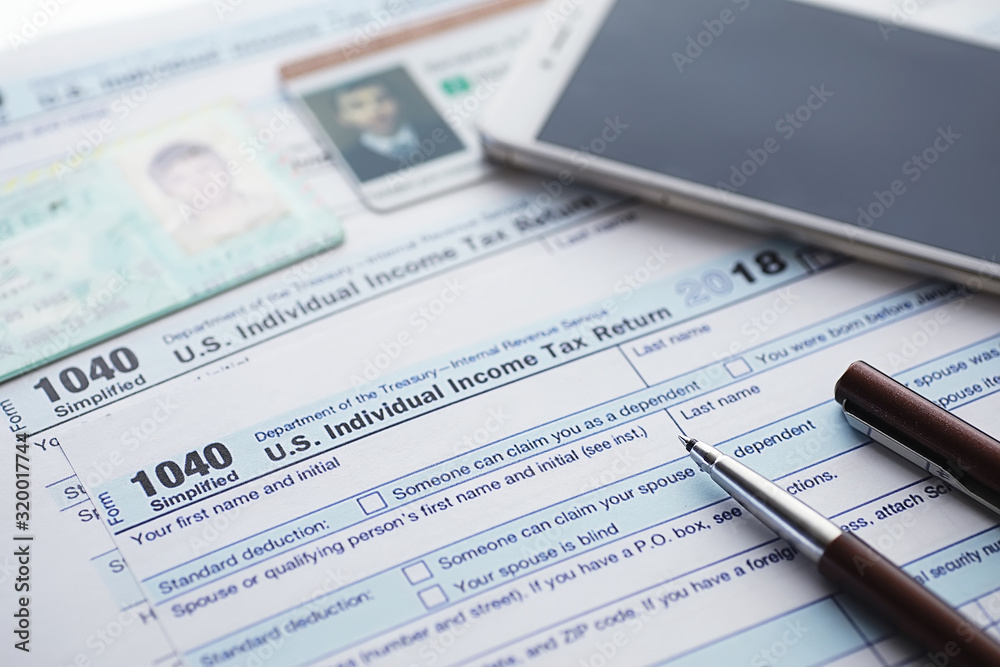 Annual tax reporting. Tax form on the table. Financial statements for ...