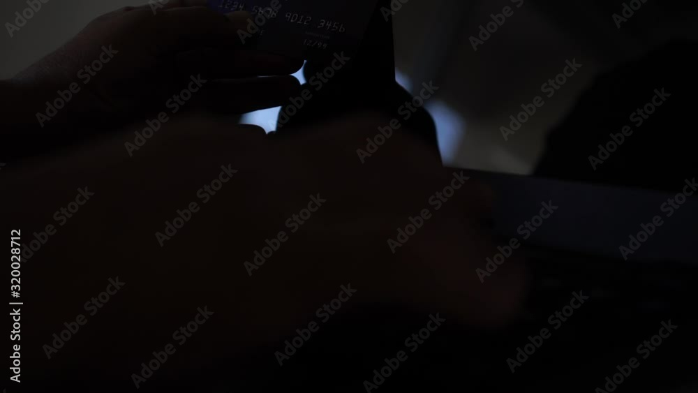 Hands of hacker or cyber crime typing coding keys on laptop keyboard ...