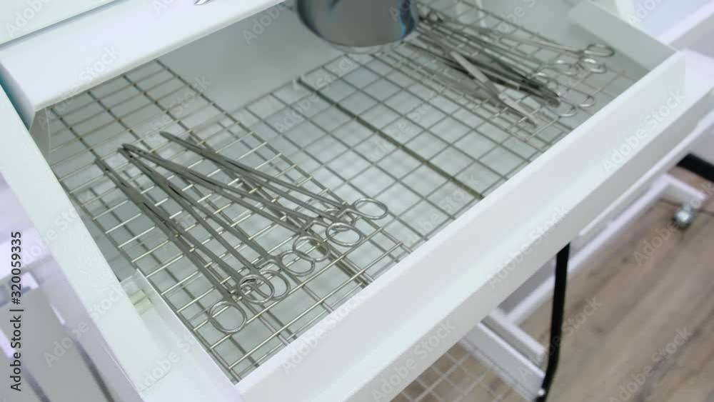 Close up hands doctor opens sterile medical instrument. Surgeon ...