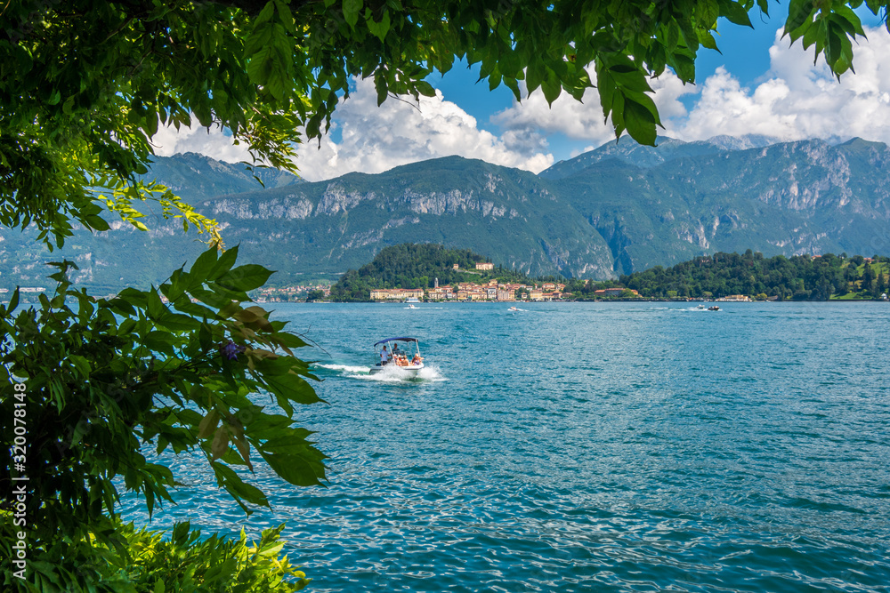 Picturesque view of the blue waters of Lake Como with floating motor ...