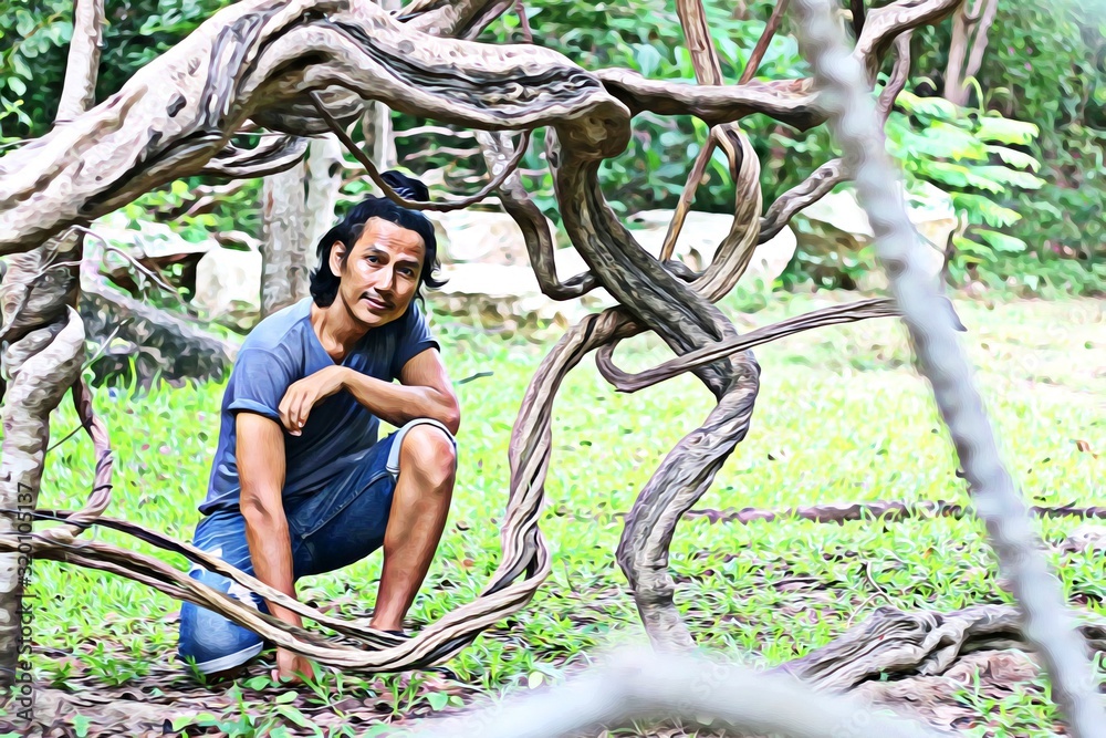 Asian Thai middle aged man black long hair and bun sitting outdoor ...