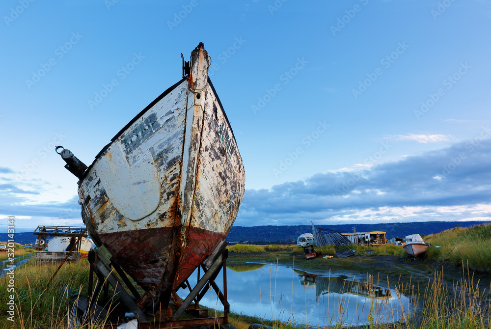 Derelict boats bathed in golden sun lights at Homer Spit, Alaska at ...