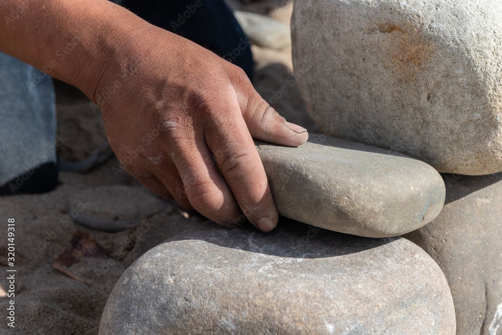 Foto de Rugged hands of a craftsman holding a perfectly shaped flat ...