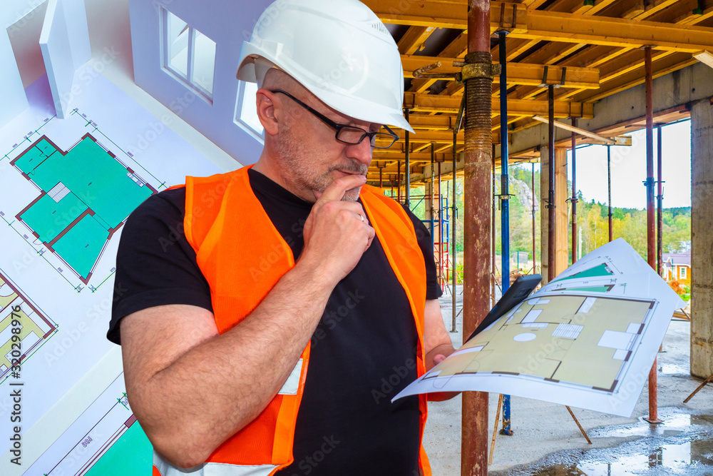 Build. Man in a helmet at a construction site. Real estate business ...