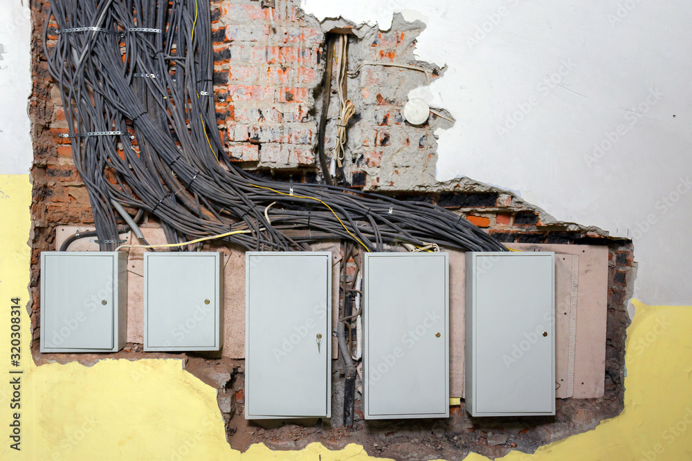 Installation and connection of electrical switchboards. Laying power ...