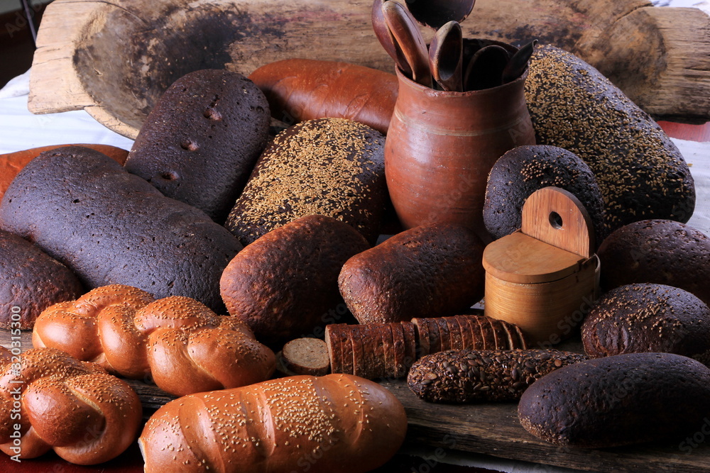 Fresh collection of bread and wheat on the table. Collection of ...