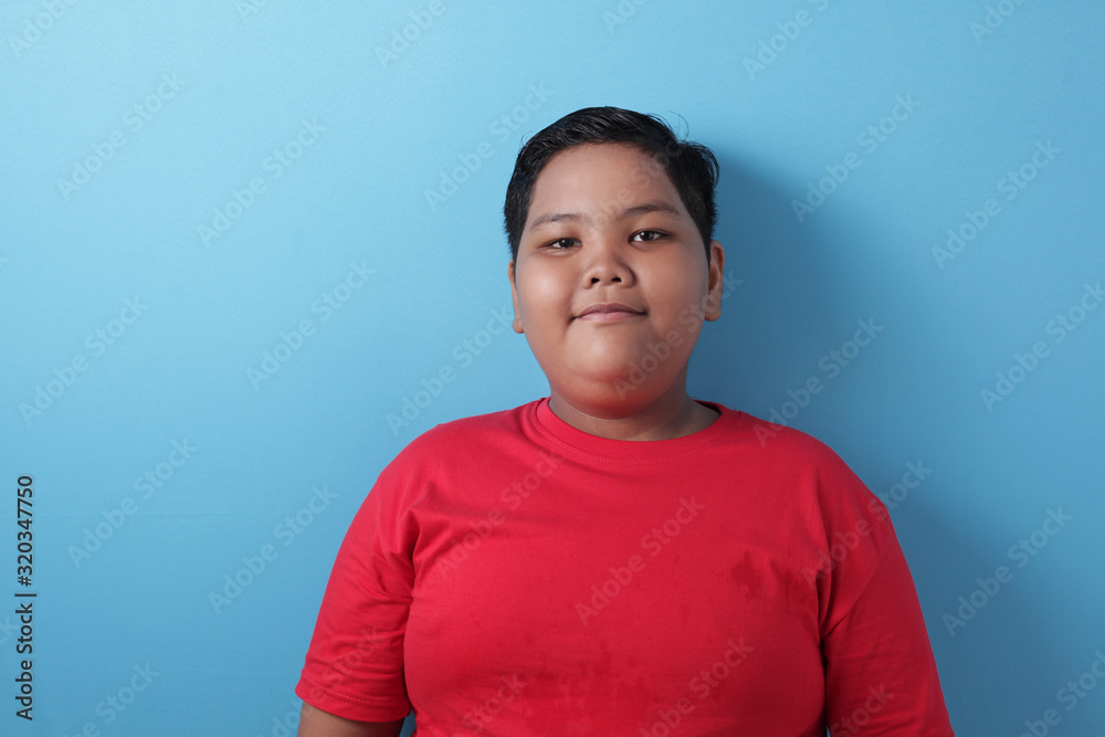 Cute Fat Asian Boy Looking At Camera And Smiling Happily Stock Photo