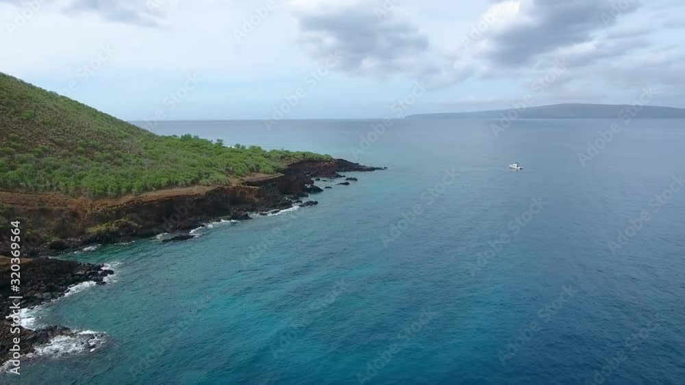 Aerialfootage of Oneuli black sand beach and Puu Olai cinder cone, Maui ...