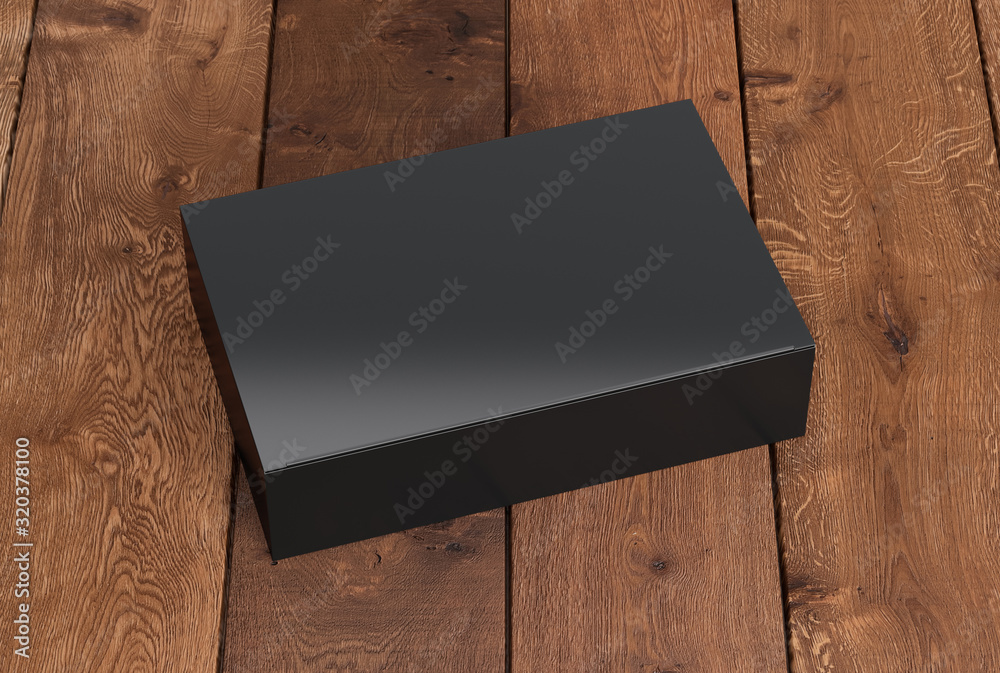Blank black wide flat box with closed hinged flap lid on dark wooden ...