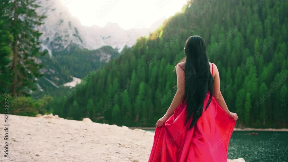 Backlight sun flare, Mysterious woman long black dark hair in red long ...
