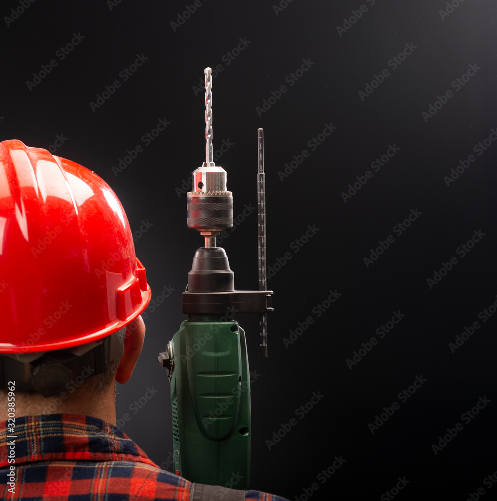 Electrical worker with a pneumatic drill presses Stock Photo | Adobe Stock