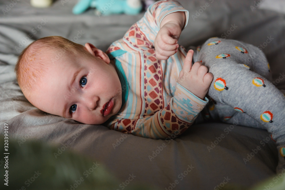 Cute young boy laying on the bed Stock Photo | Adobe Stock