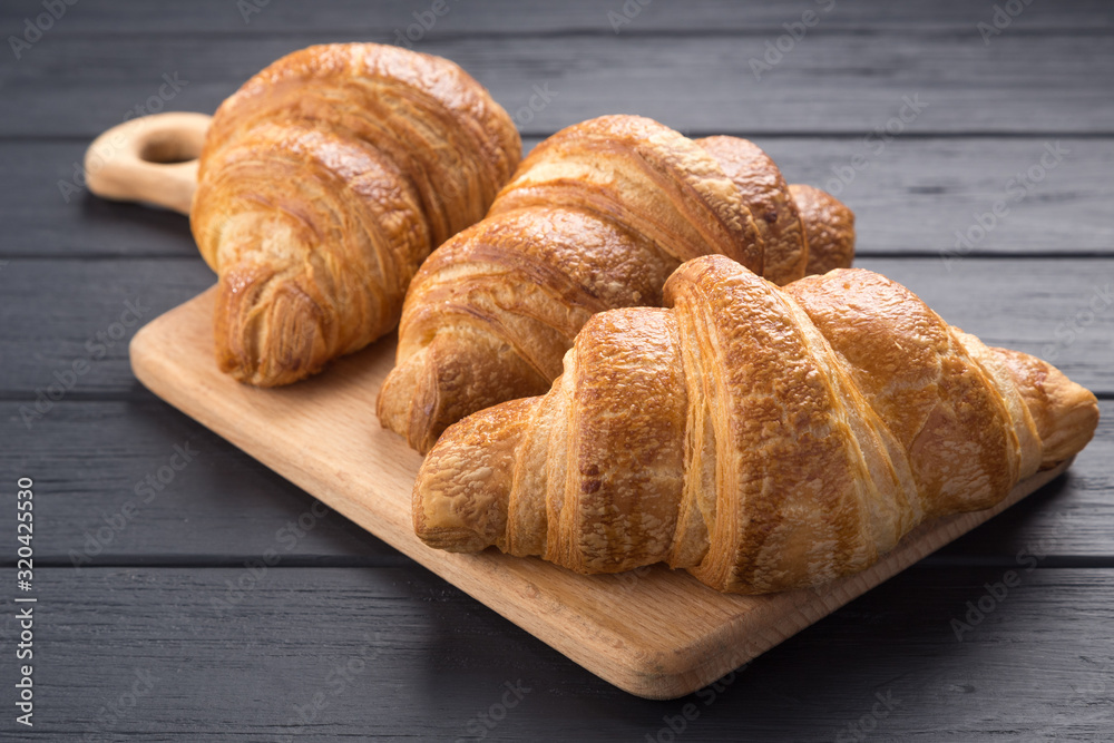 Croissants on a black wooden table. Croissant breakfast. Croissants on ...