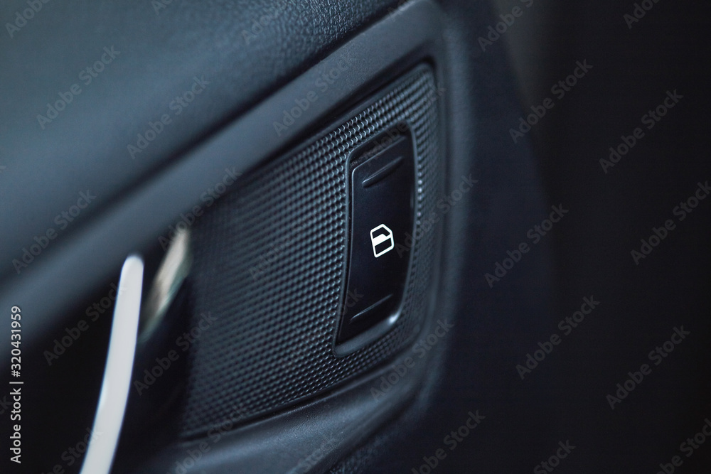 car interior details of door handle with windows controls and ...