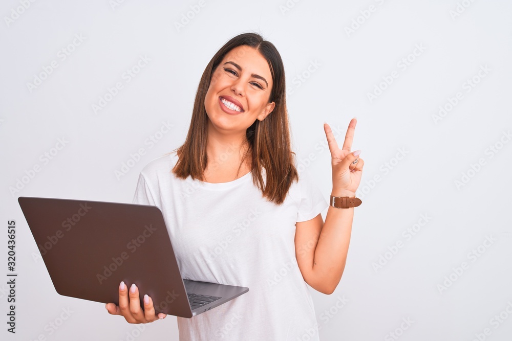 Beautiful young woman working using computer laptop over white ...