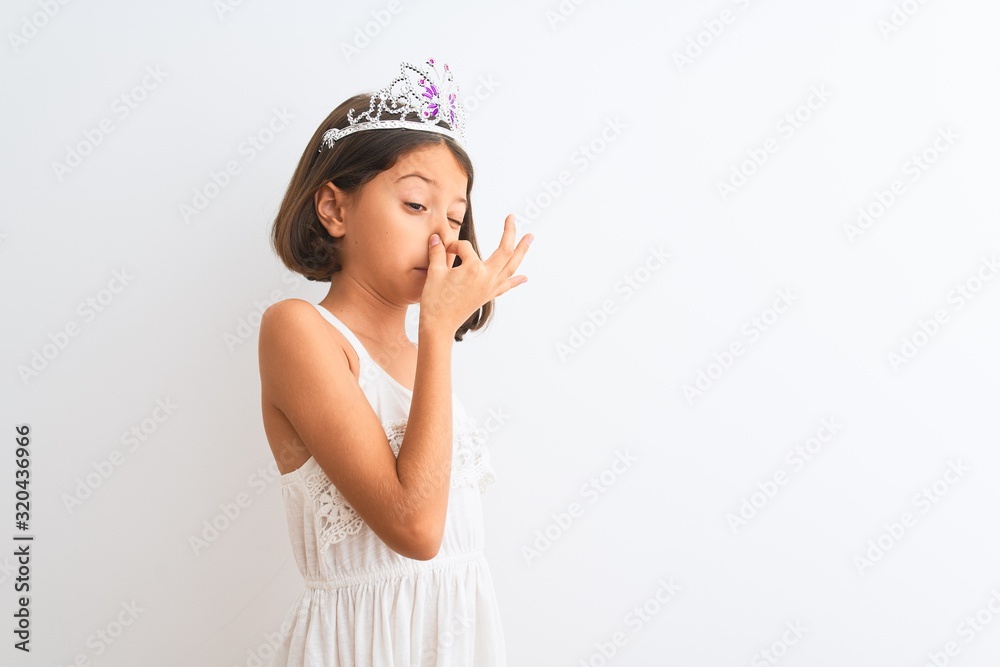 Beautiful child girl wearing princess crown standing over isolated ...