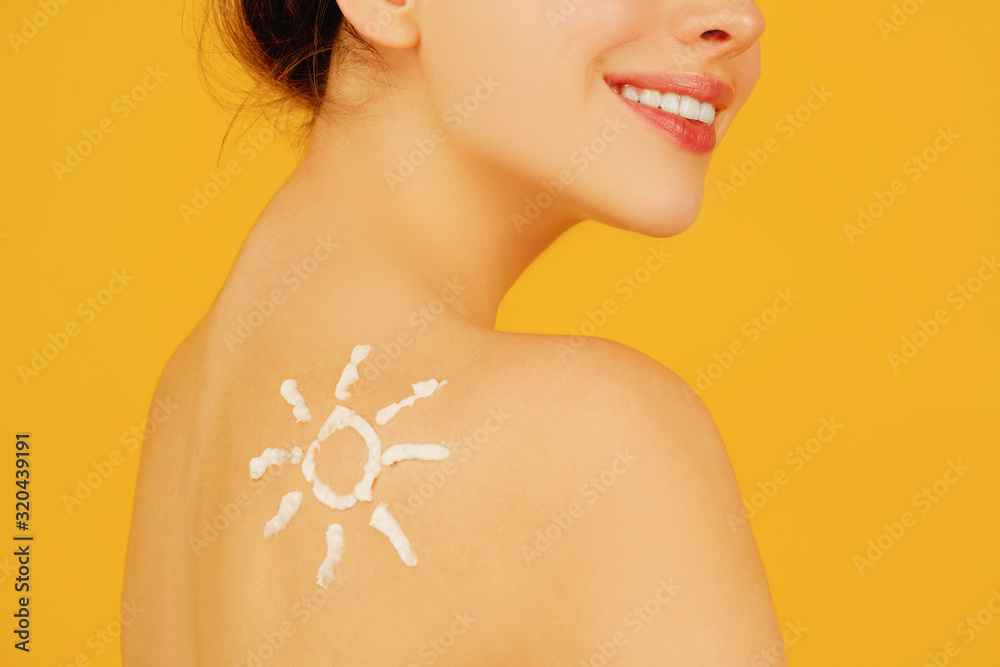 SPF. Smiling womans back with sun cream at the beach. Summer concept ...
