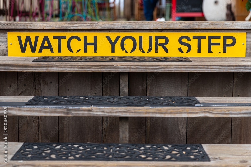 Watch your Step sign on a wooden set of stairs Stock Photo | Adobe Stock