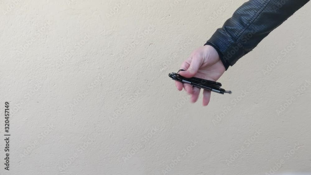 hand making tricks with butterfly knife on light background, butterfly ...