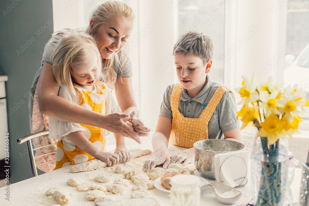 Mom cooking with kids on the kitchen Stock Photo | Adobe Stock