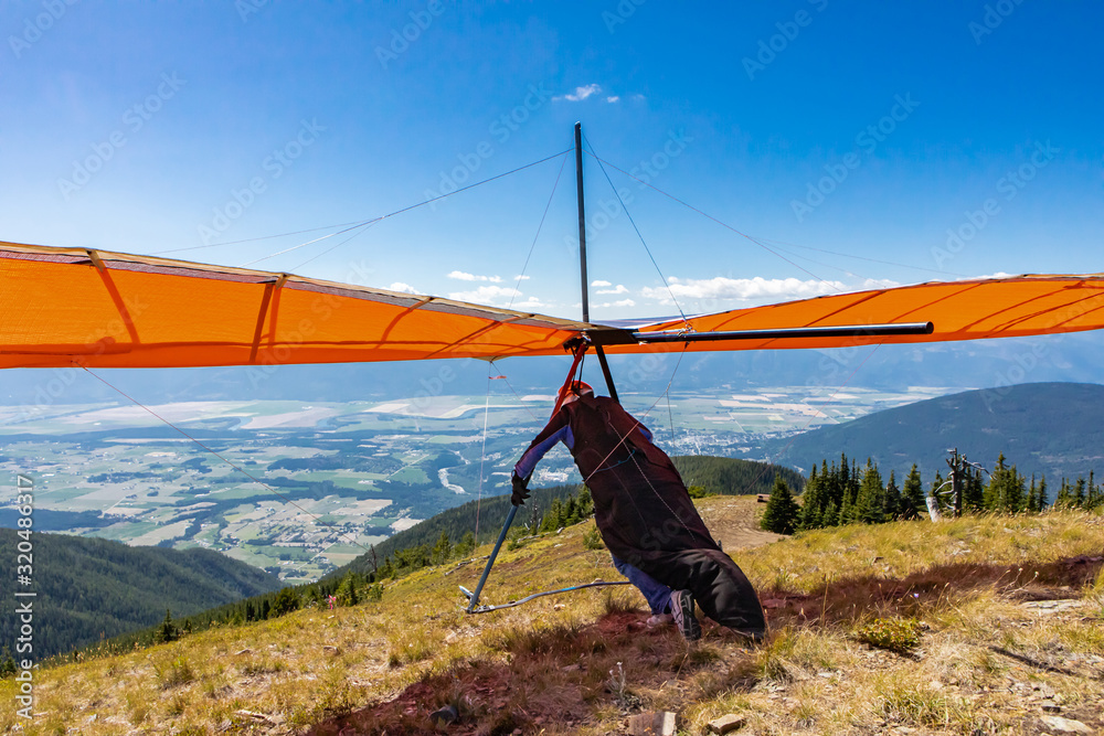 Extremal air sport competition. A Hang glider man taking off. Adrenalin ...