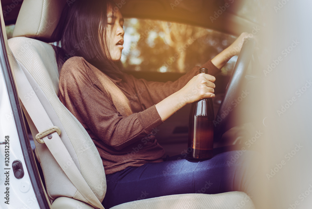 Drunk asian woman drinking alcohol while driving car on road,Women ...
