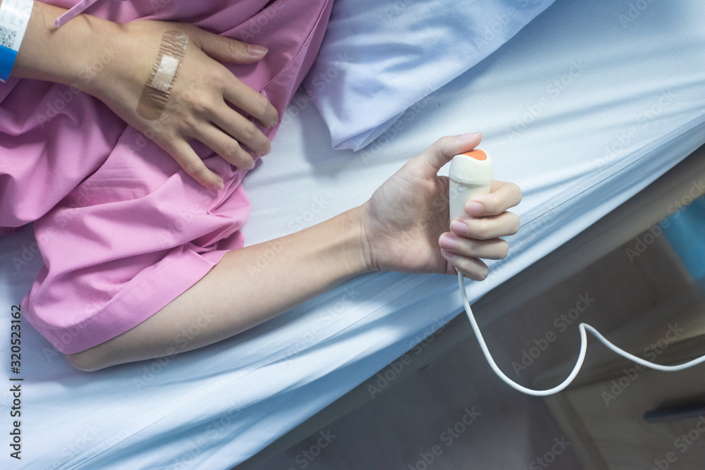Patient hands press nurse call button on the bed in hospital, Hand of ...