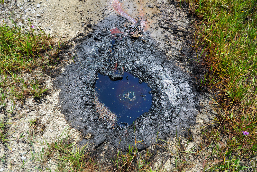 Foto de Blood of the earth. Spills of crude oil on the soil surface ...