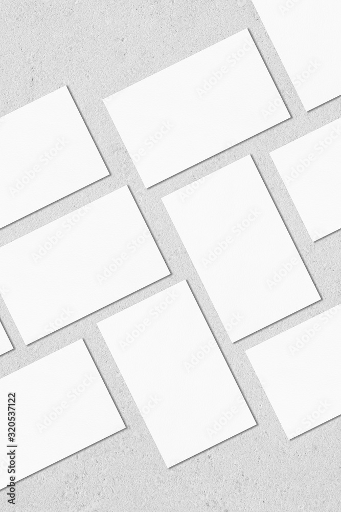 Closeup of empty white rectangle business card mockups lying diagonally ...