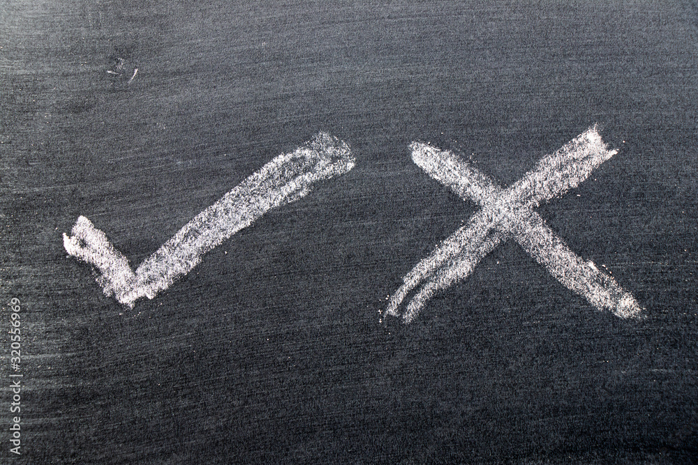 White color chalk hand drawing in check mark of right and wrong shape ...
