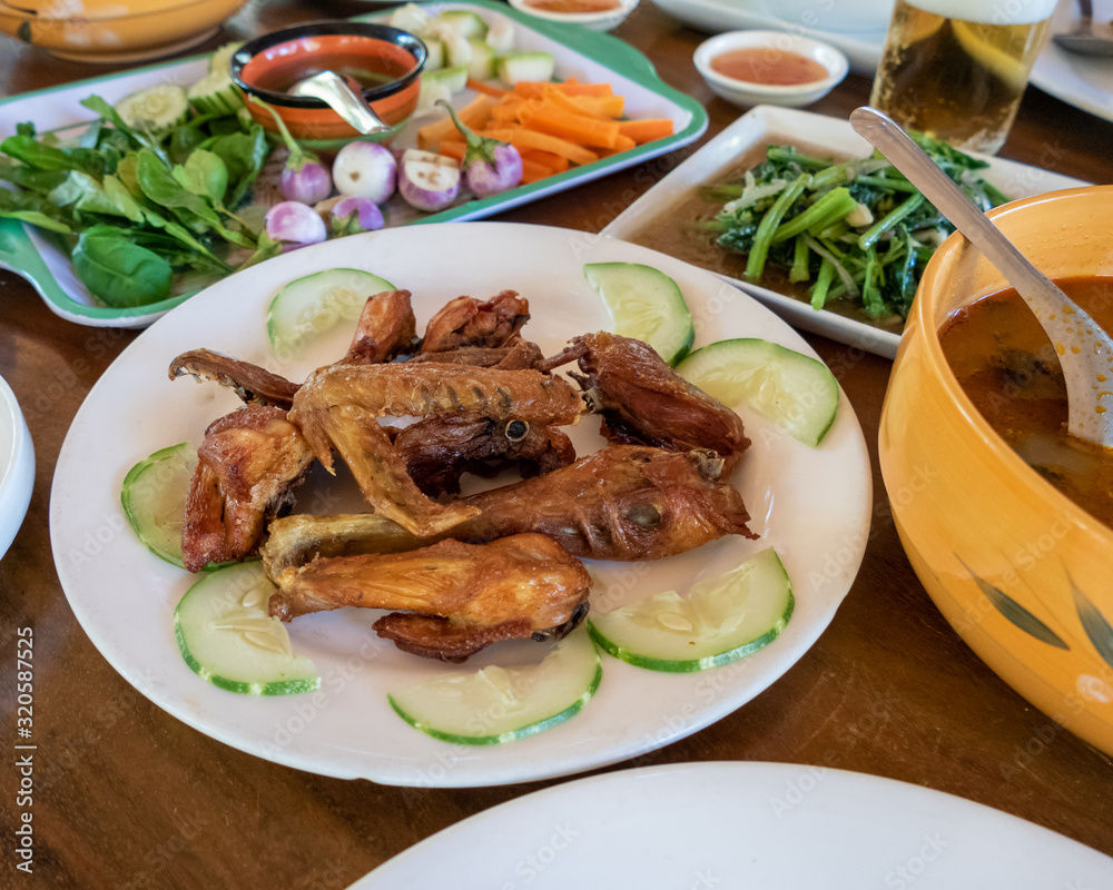 Selection of burmese dishes in rural Myanmar with skinny chicken and ...