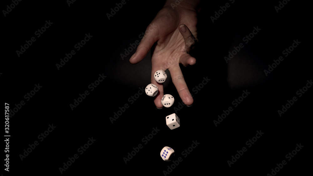 Hand throwing gambling dice on table, black background Stock Photo ...