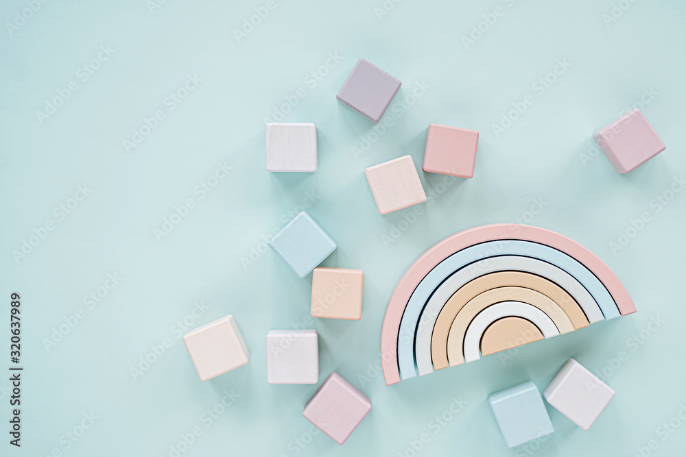 Wooden rainbow, colorful toy blocks. Stylish baby toys on light blue ...