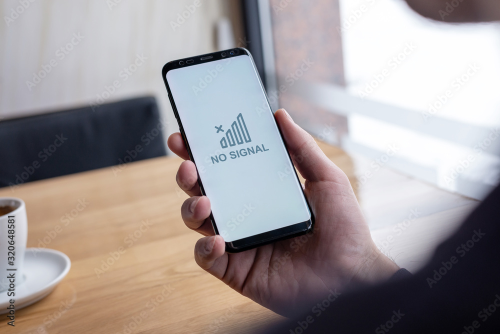 No mobile network signal on smar phone display in man hand. The concept ...