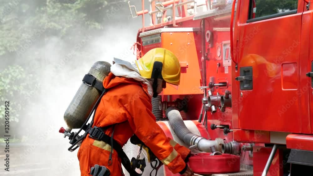 Video Stock Firefighter fighting with fire flame protection property ...