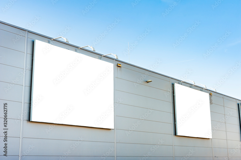 Advertising billboards mockups on the wall of warehouse/factory ...