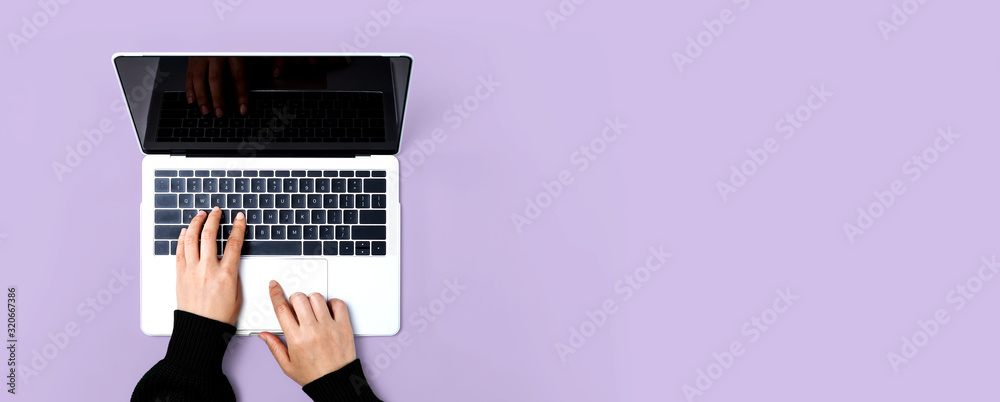Person using a laptop computer on a solid color background Stock Photo ...