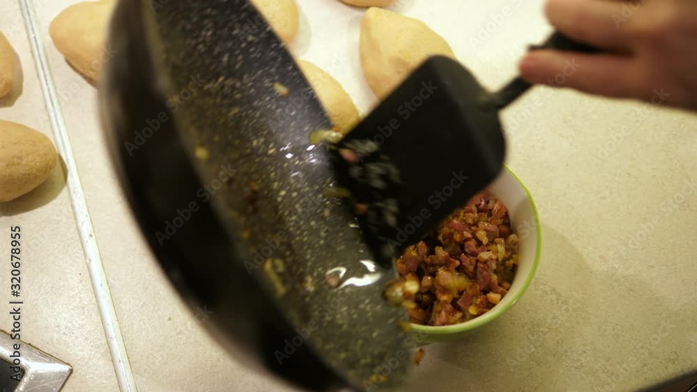 Cooking Bacon bits for Cepelinai. Traditional food made with potatoes ...