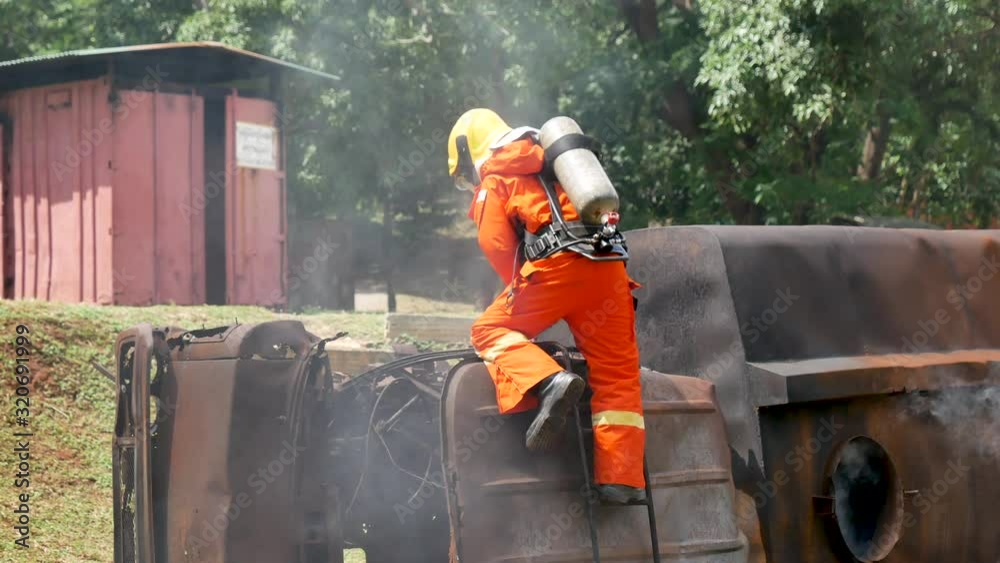 Firefighter fighting with fire flame protection property. Fireman wear ...