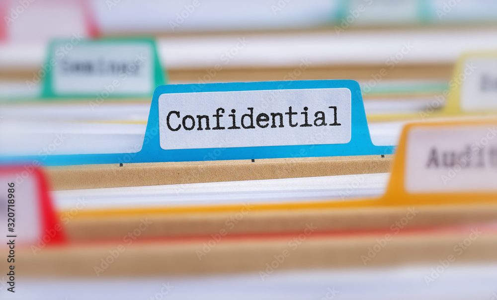 File folders with a tab labeled Confidential Stock Photo | Adobe Stock