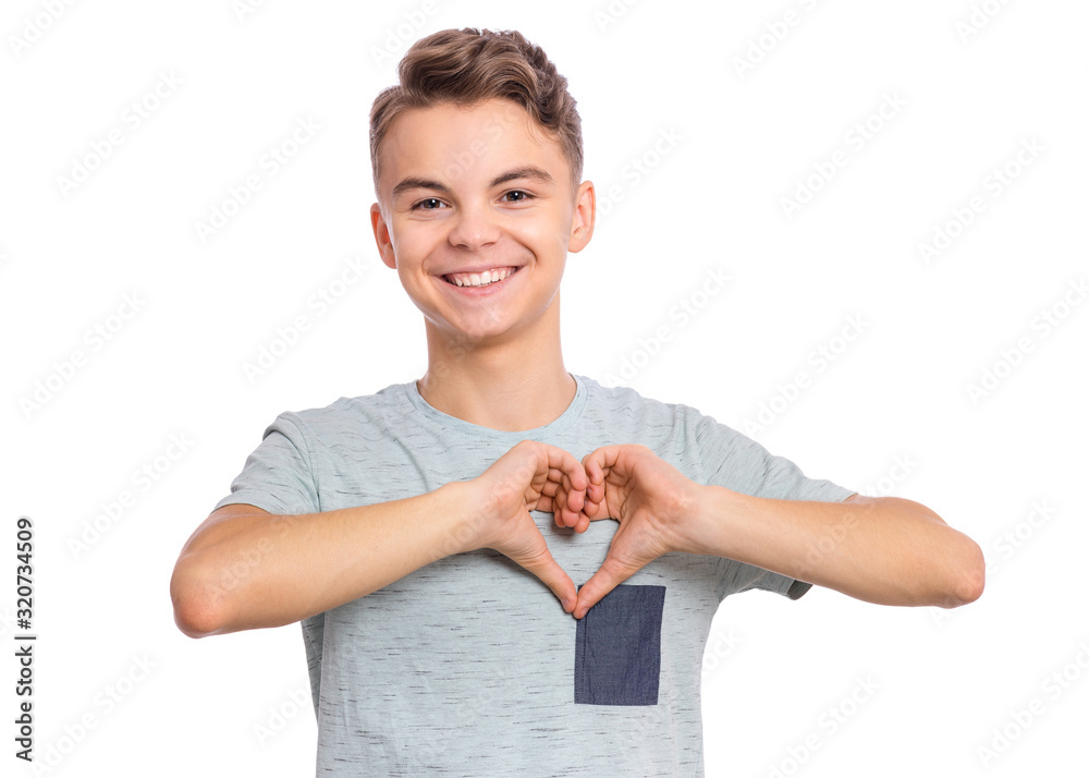 Happy teen boy making heart, isolated on white background. Smiling ...