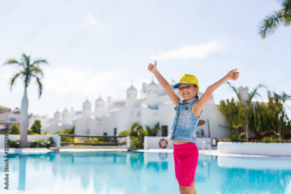 Beautiful little girl spread her arms standing near swimming pool Stock ...