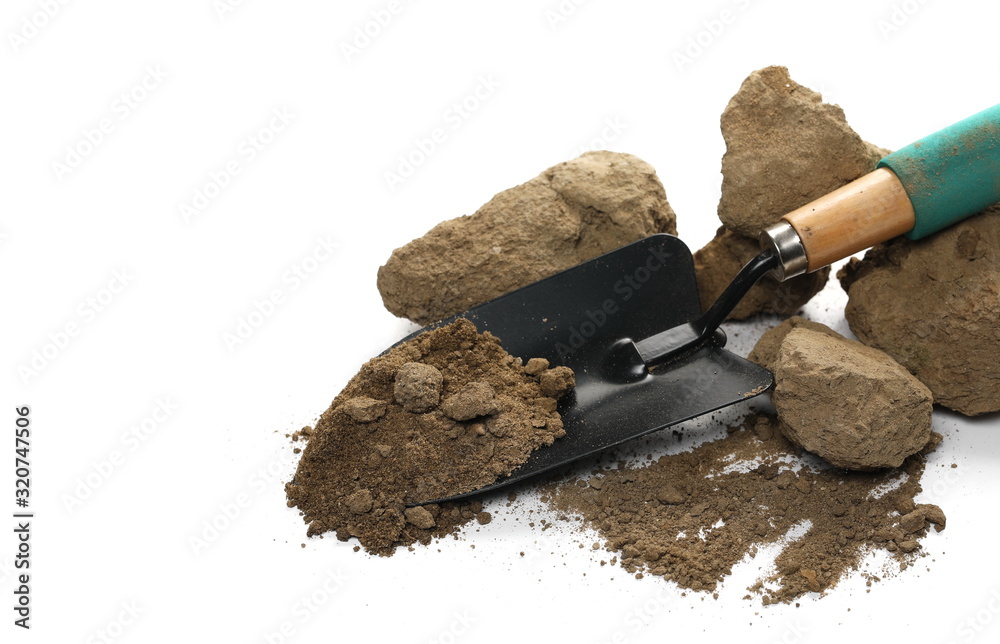 Dirt, soil pile and chunks with gardening trowel, shovel for planting ...