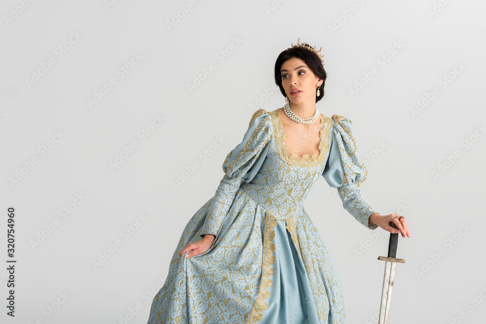 attractive queen with crown holding sword isolated on grey Stock Photo ...