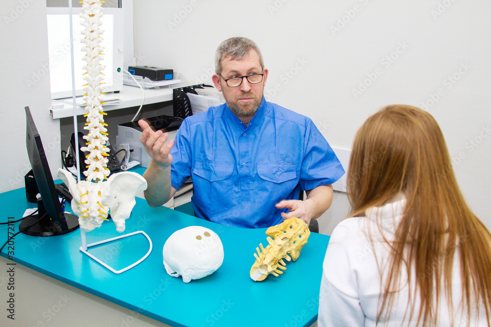 The doctor osteopath and chiropractor in the hospital explains to the ...