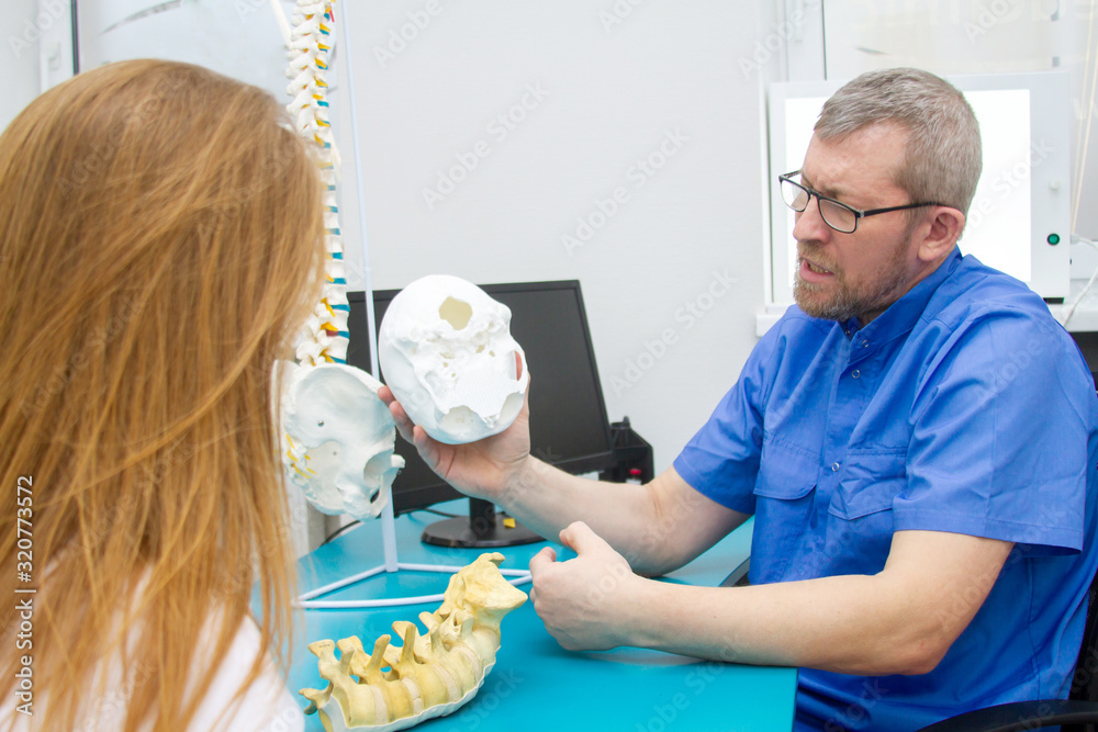 The doctor osteopath and chiropractor in the hospital explains to the ...